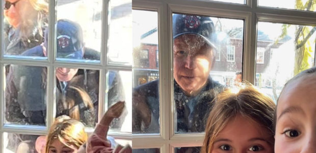 Scary shot of creepy Joe Biden peering through glass at small children ...